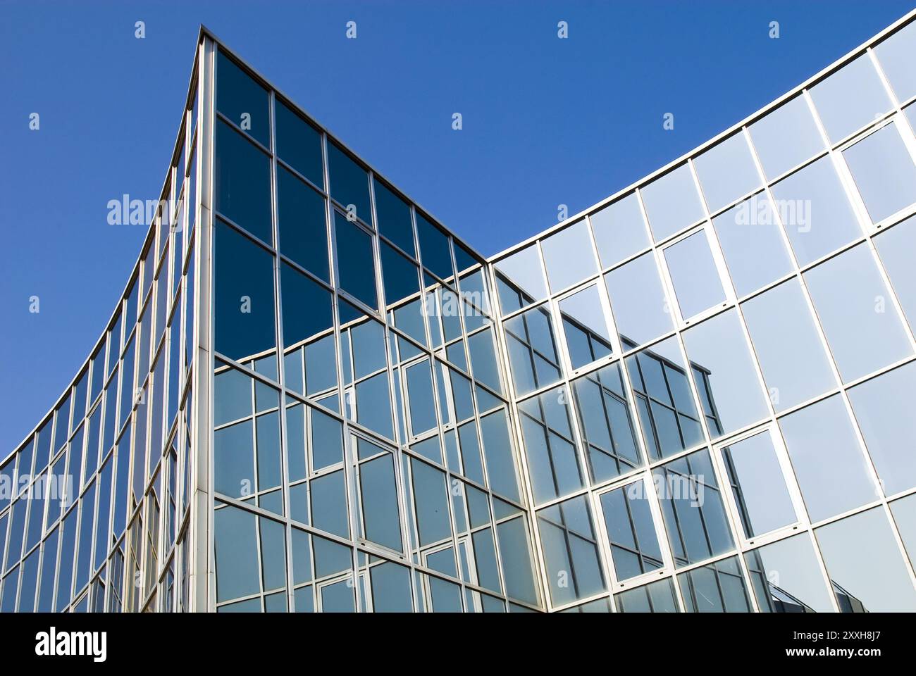 Reflections in the glass facade of an office building Stock Photo - Alamy