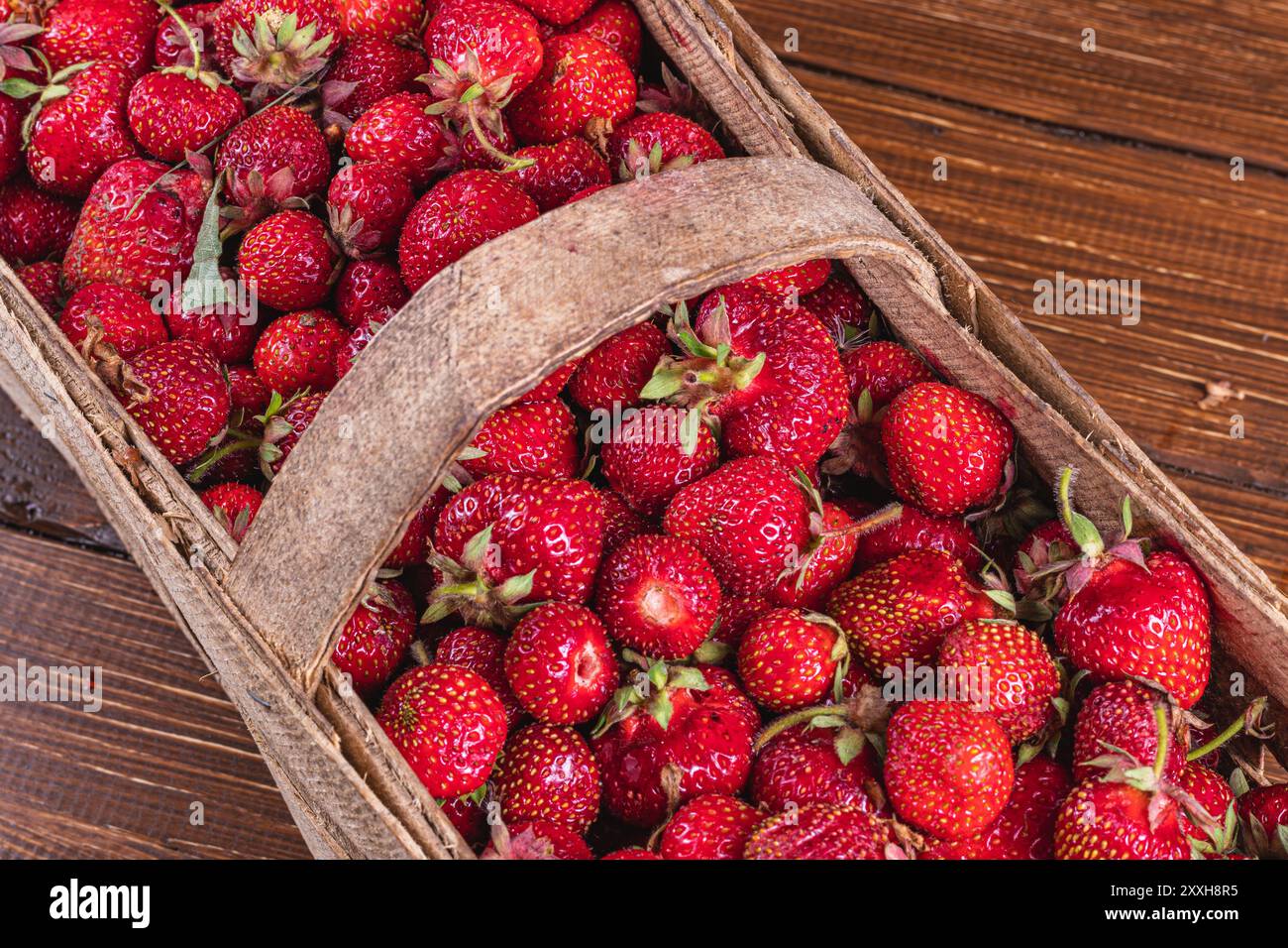 ripe sweet strawberries in wooden wicker box on table top view Stock ...