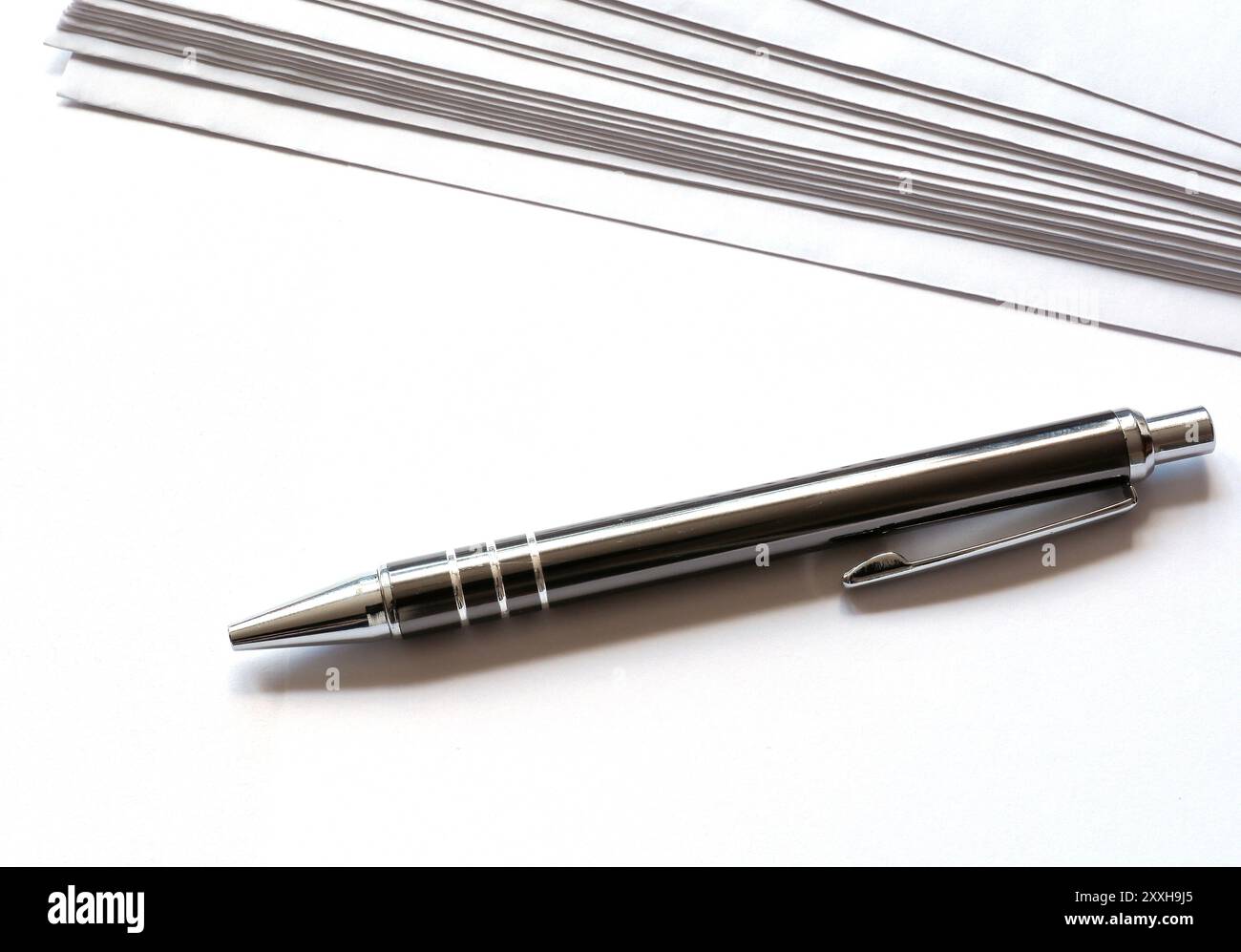 Unwritten writing paper and a biro lie on a table Stock Photo - Alamy