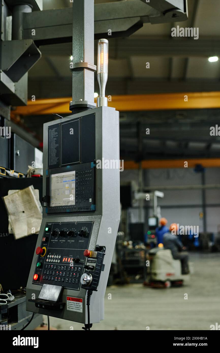 Industrial machine equipped with control panel operating in spacious ...