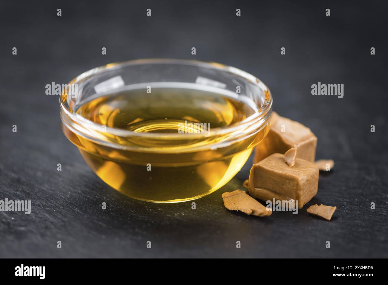 Syrup (Caramel taste) on a vintage slate slab (close-up shot, selective ...