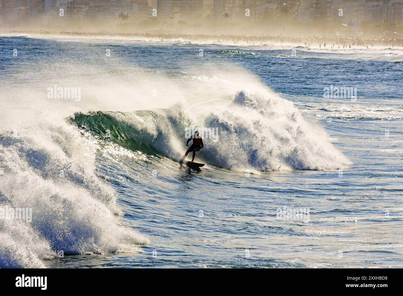 Surfer and wave with water spray at Ipanema beach in Rio de Janeiro ...