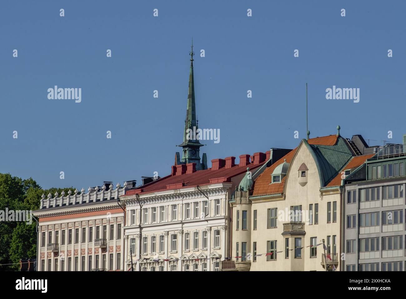 Historic buildings with decorative facades and a church tower against a ...