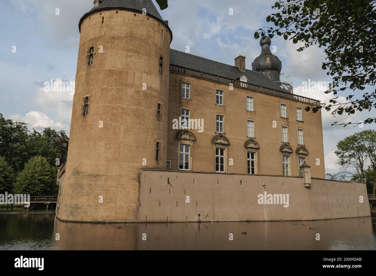 An imposing medieval castle with a high watchtower, reflected in the ...