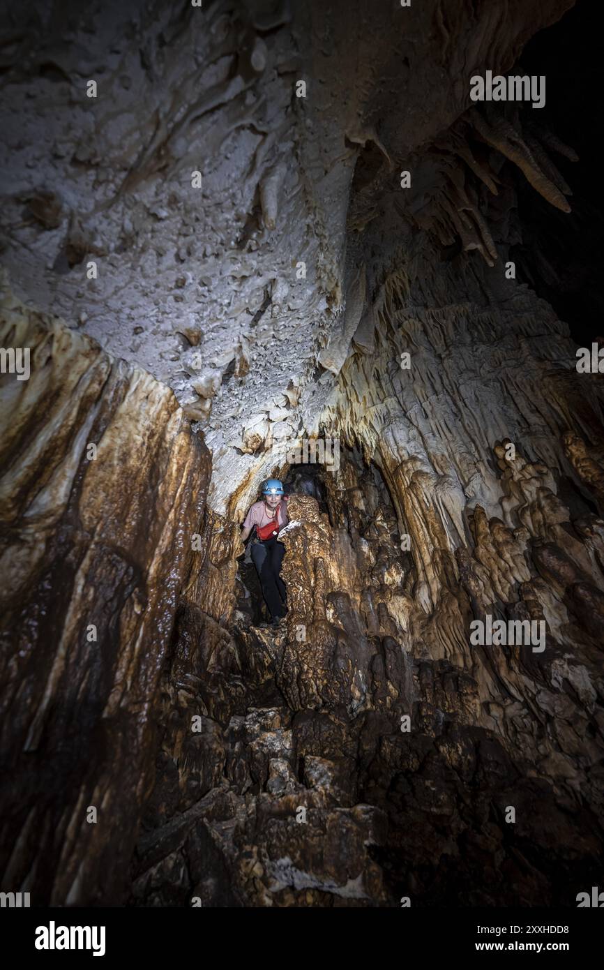 Woman exploring stalactite cave, Terciopelo Cave, Barra Honda National ...