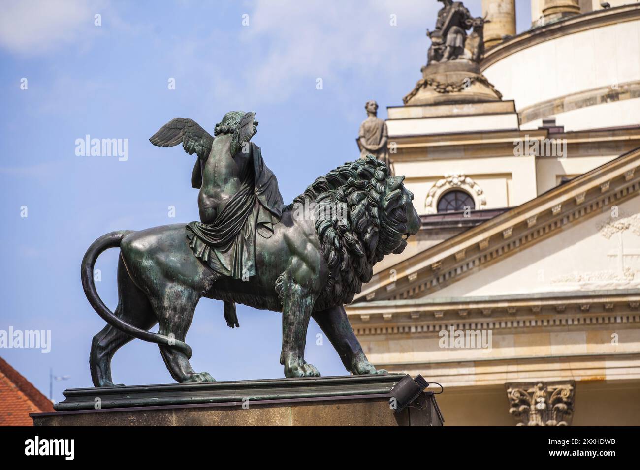 Statue of an angel riding a lion and playing the harp, with the French ...