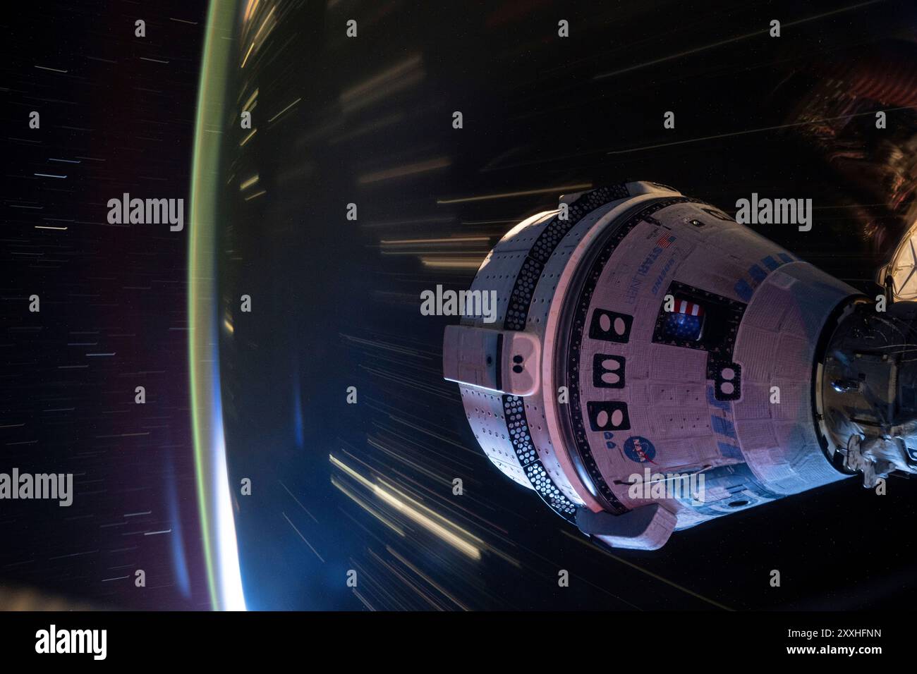 In this long-exposure photo provided by NASA, Boeing's Starliner ...