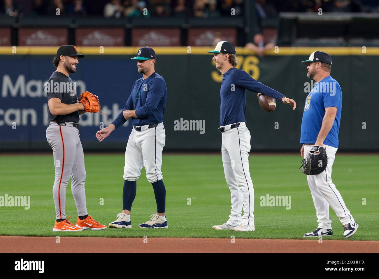 San Francisco Giants pitcher Robbie Ray, from left, speaks with Seattle ...