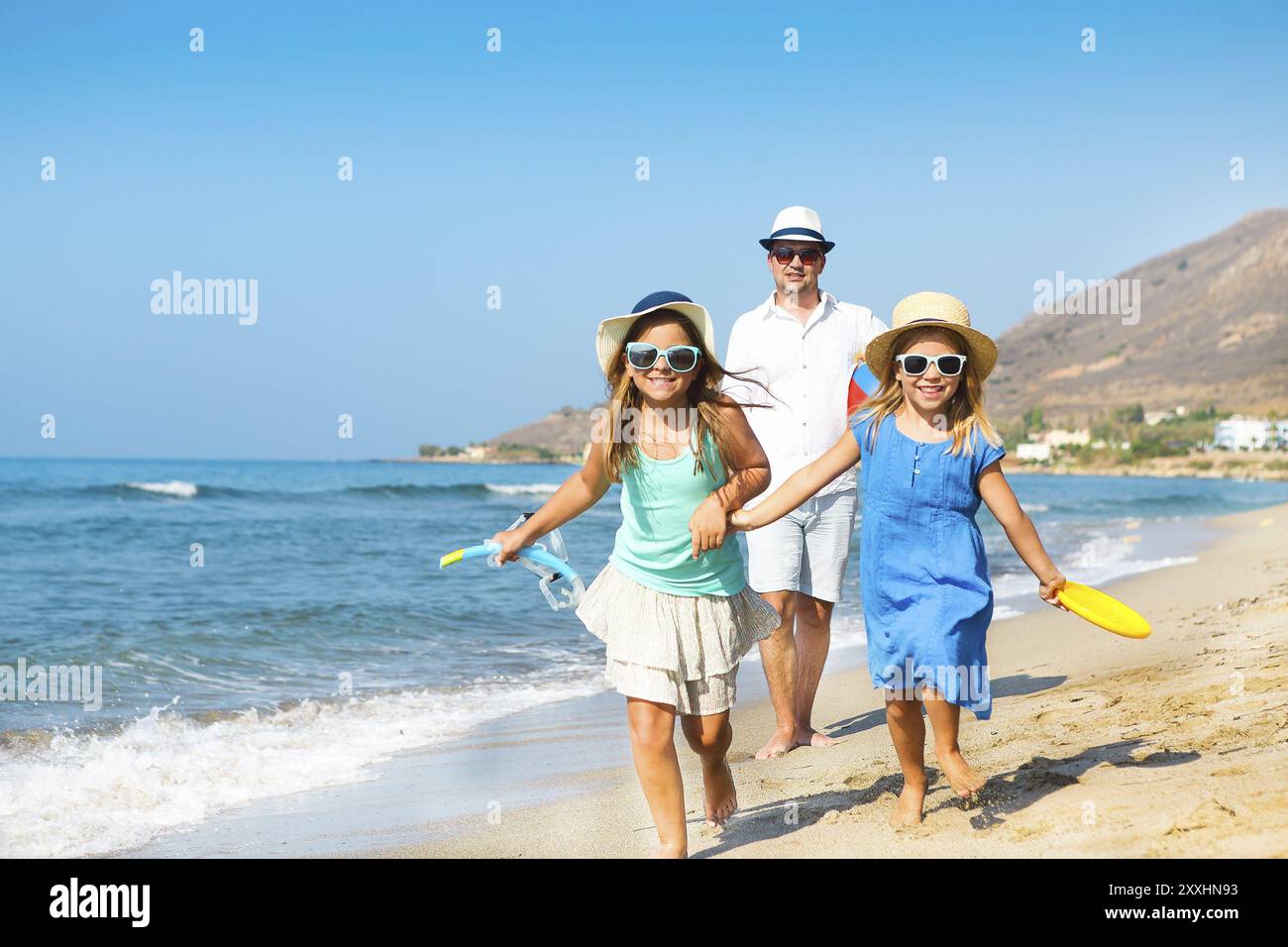 Happy young family having fun running on beach at sunset. Family ...