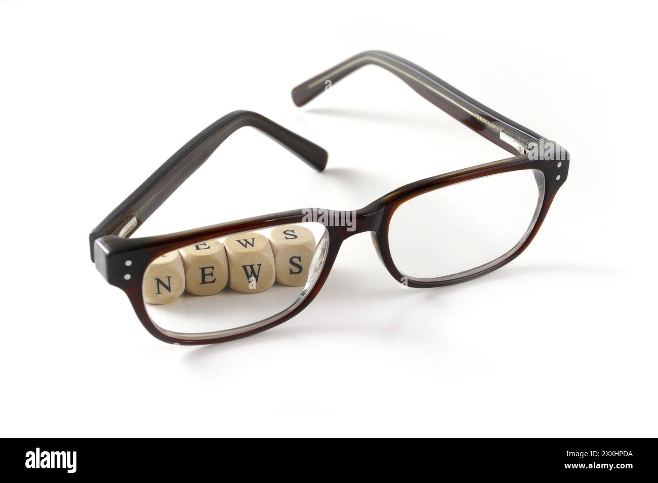 News message written in wooden blocks behind glasses, isolated on white ...