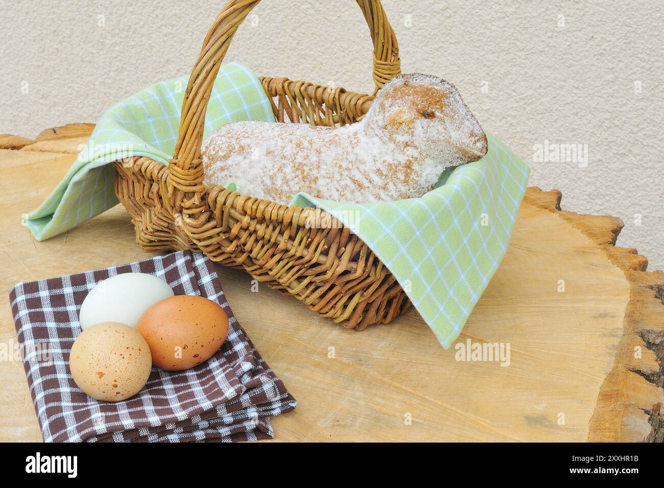 Baked lamb-shaped dough. Baked Easter lamb in a raffia basket Stock ...
