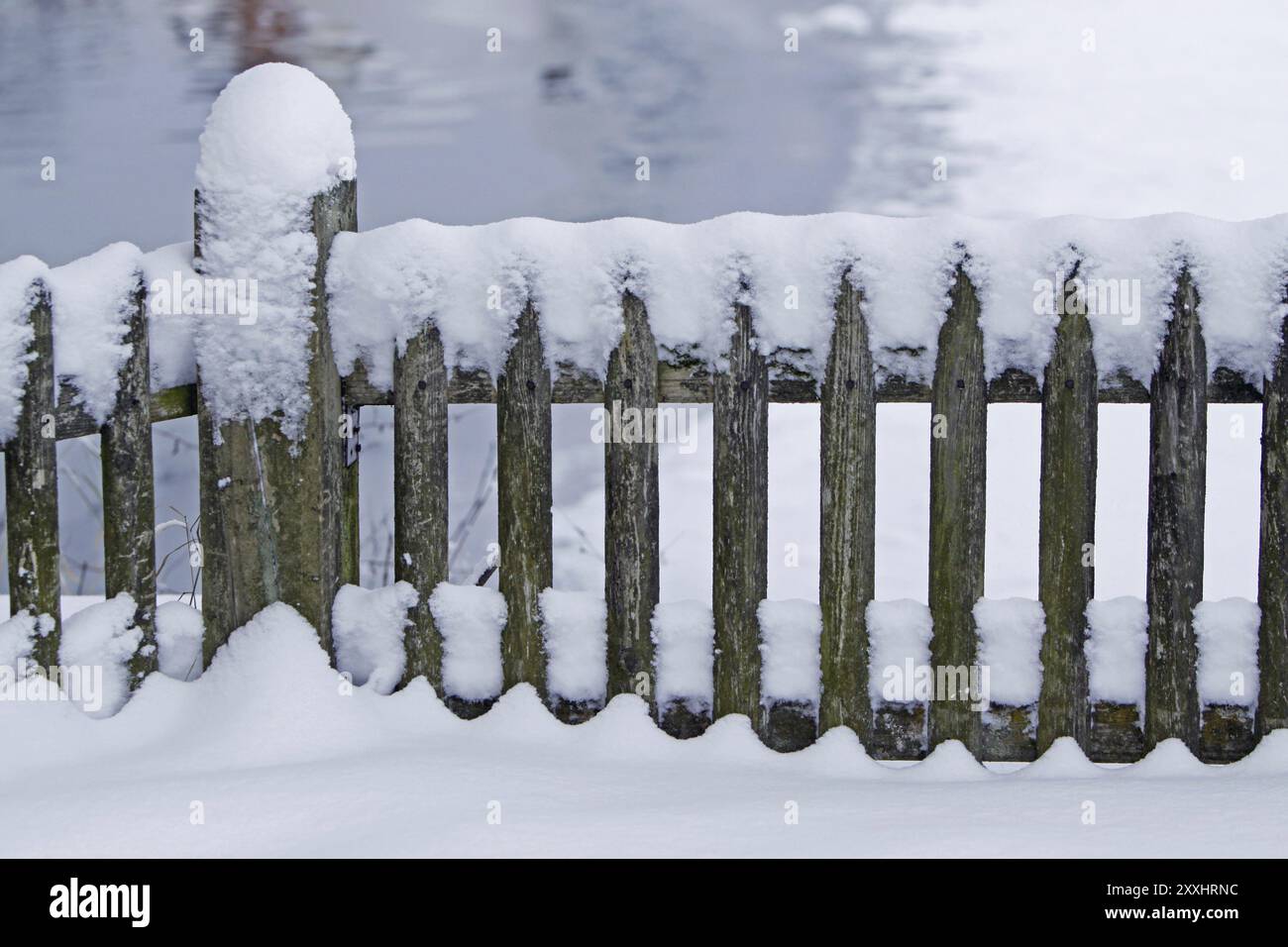 Snow-covered wooden fence Stock Photo - Alamy