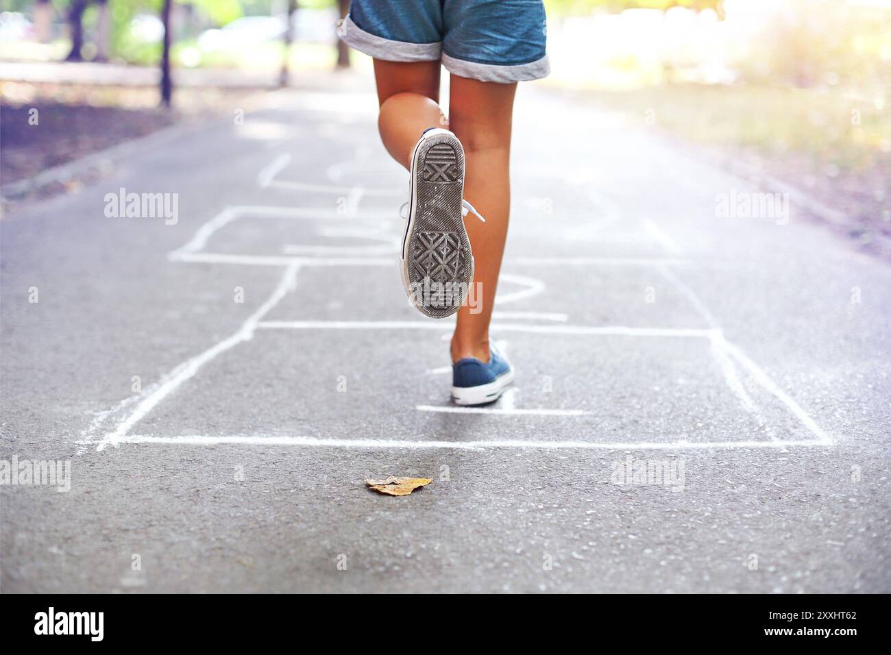 Kid playing hopscotch on playground outdoors, children outdoor ...