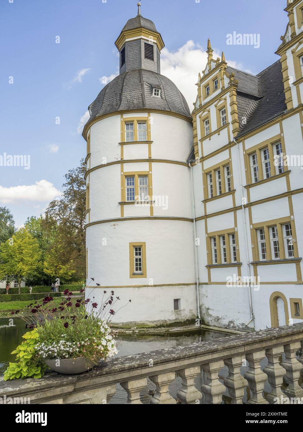 Baroque castle with tower and small water area, surrounded by ...