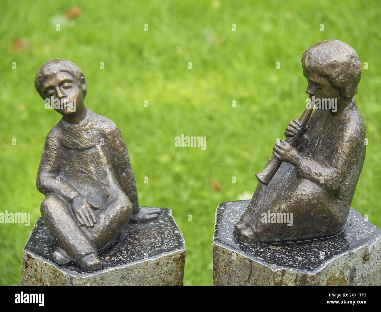 Two bronze sculptures of children in a green park, Bad Zwischenahn ...