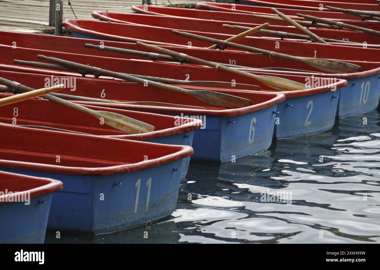 Blue and red rowing boats on a jetty Stock Photo - Alamy