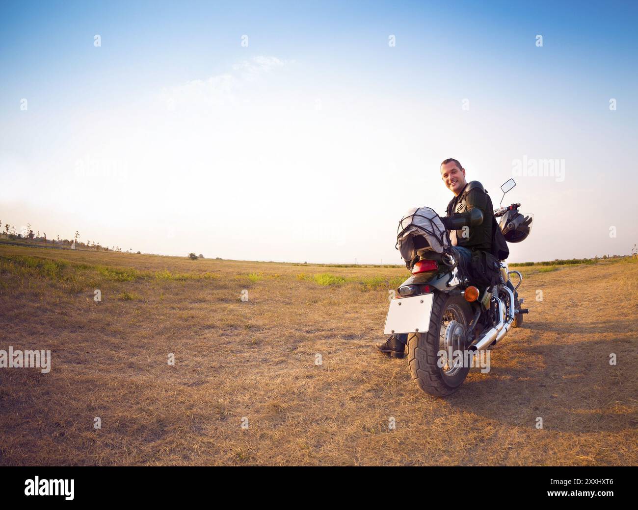 Portrait of a biker on the country road against the sky Stock Photo - Alamy