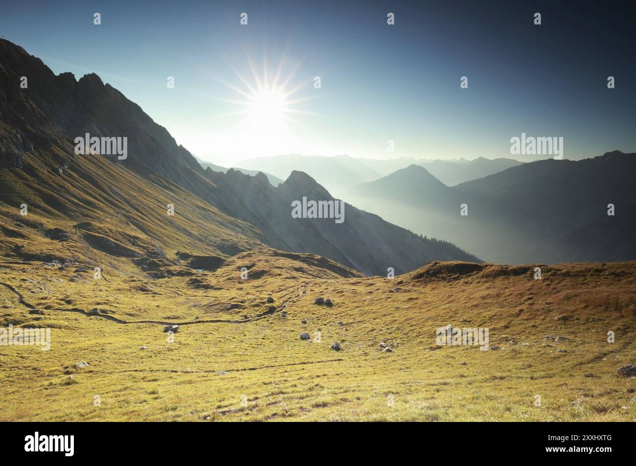 Beautiful sunrise over mountain peaks in Alps Stock Photo - Alamy