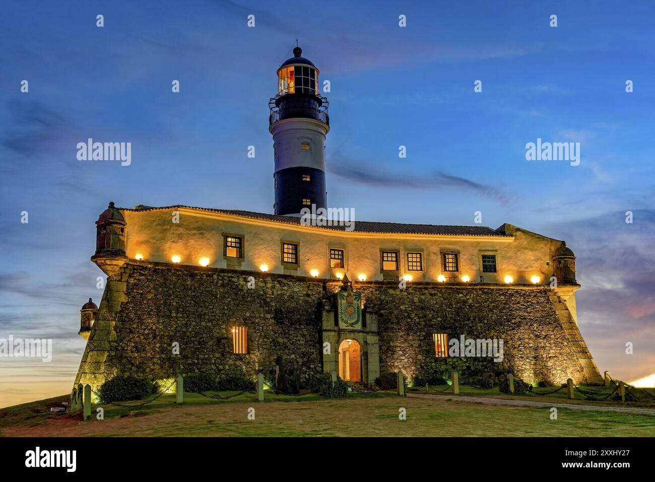 Night view of the famous and historic Barra Lighthouse on the banks of Todos os Santos bay in ...