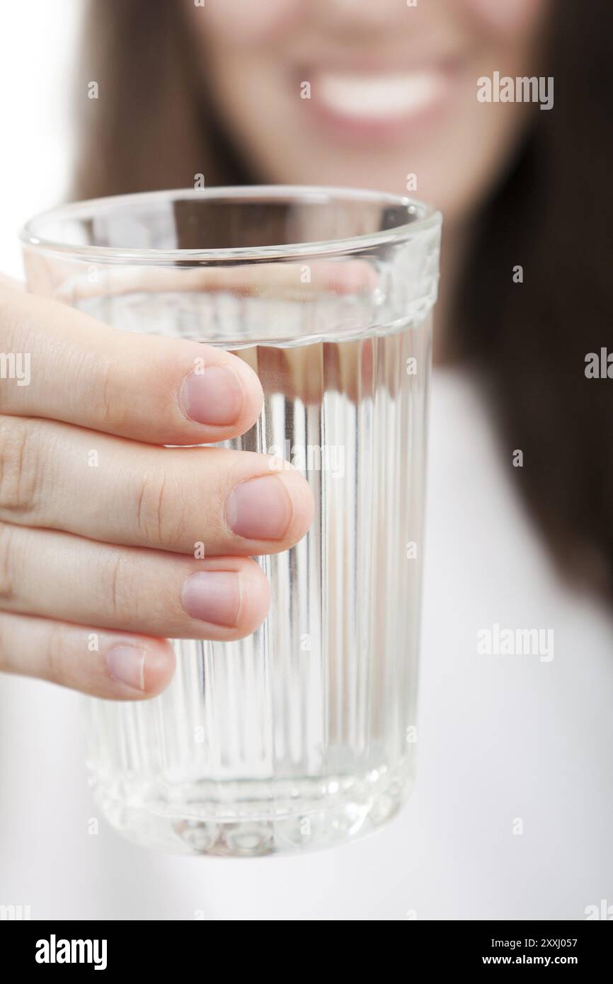 Female human hand holding liquid drink water glass Stock Photo - Alamy