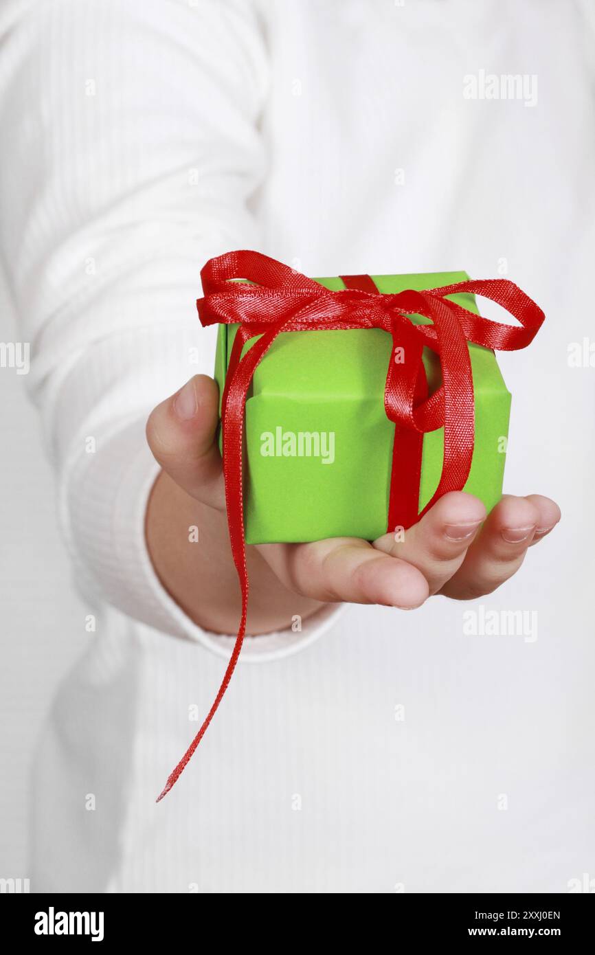 Little hand of the child holding a present Stock Photo - Alamy