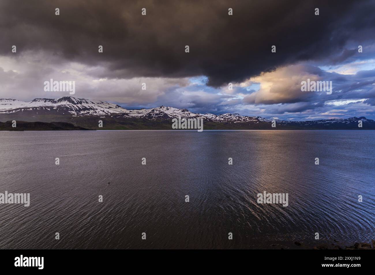 Snowy mountains of the eastern fjords with an overcast sky on Iceland ...