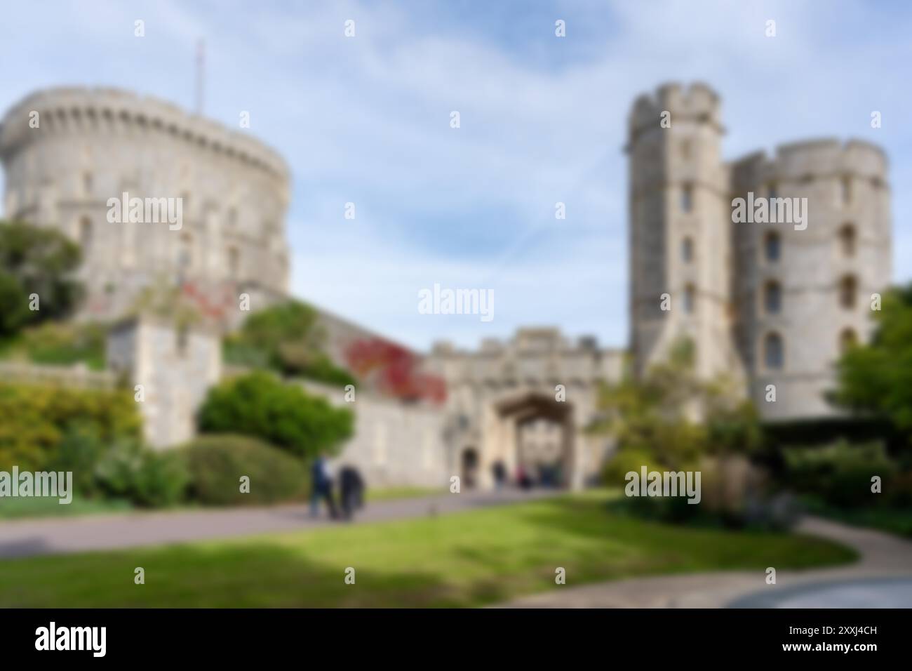 A blurred image of a castle with a walkway leading to a gate. The ...