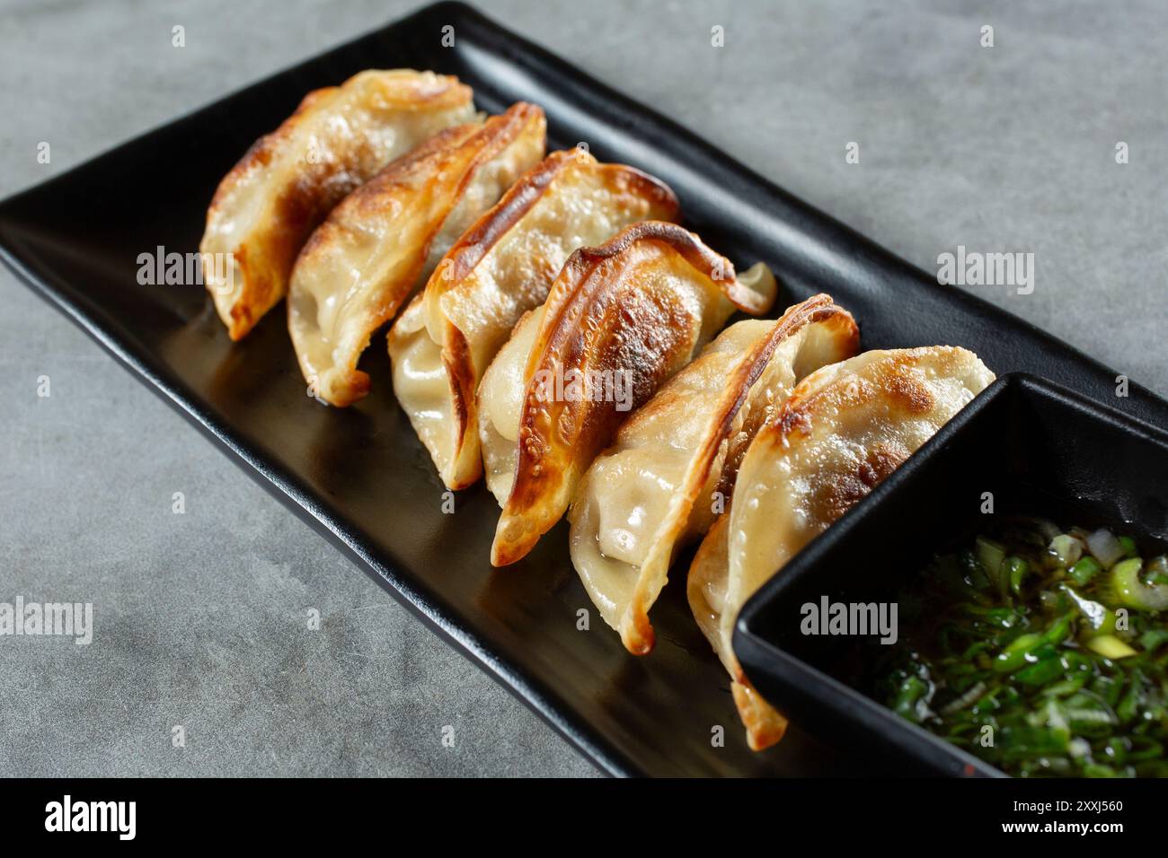 A view of a plate of fried gyoza Stock Photo - Alamy