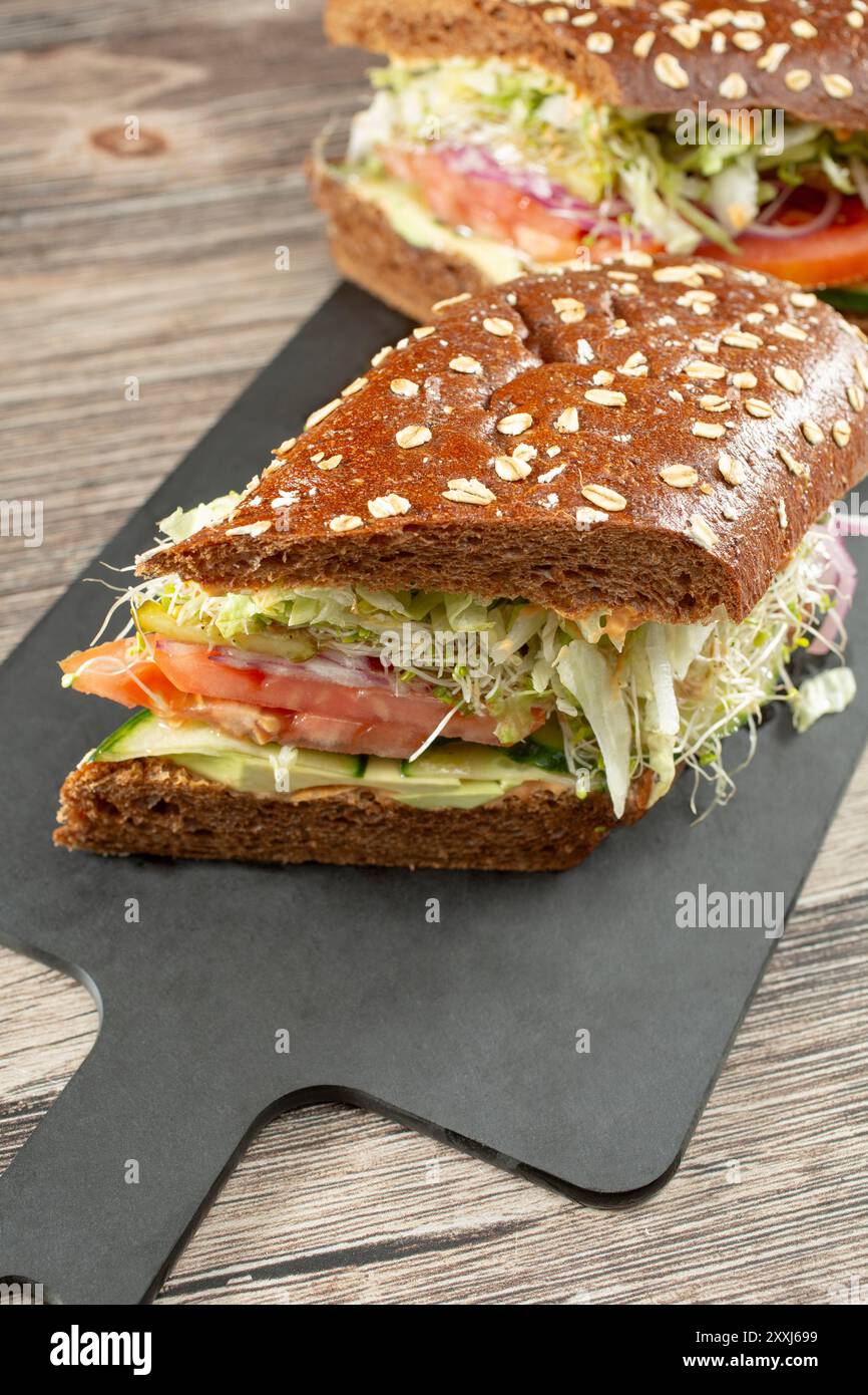 A view of a vegan sandwich on a squaw-roll, cut in half Stock Photo - Alamy