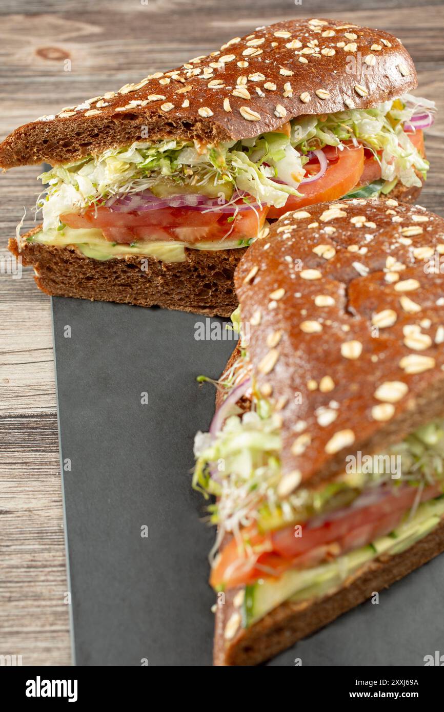 A view of a vegan sandwich on a squaw-roll, cut in half Stock Photo - Alamy