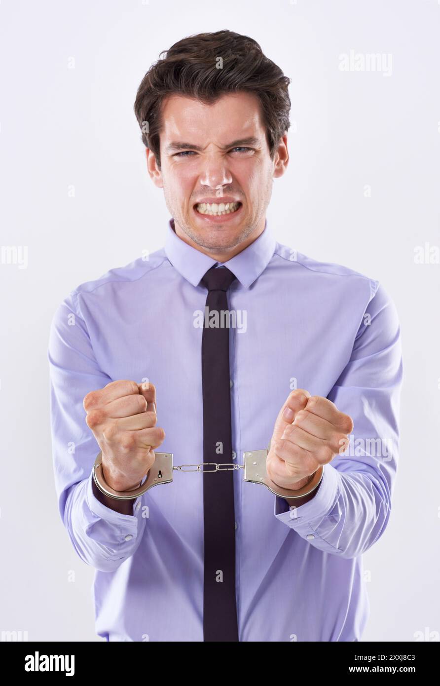Business, man and frustrated on handcuffs in studio on portrait in ...