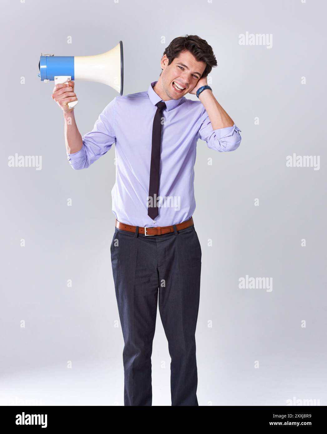 Business man, noise and megaphone by ear in studio for communication ...