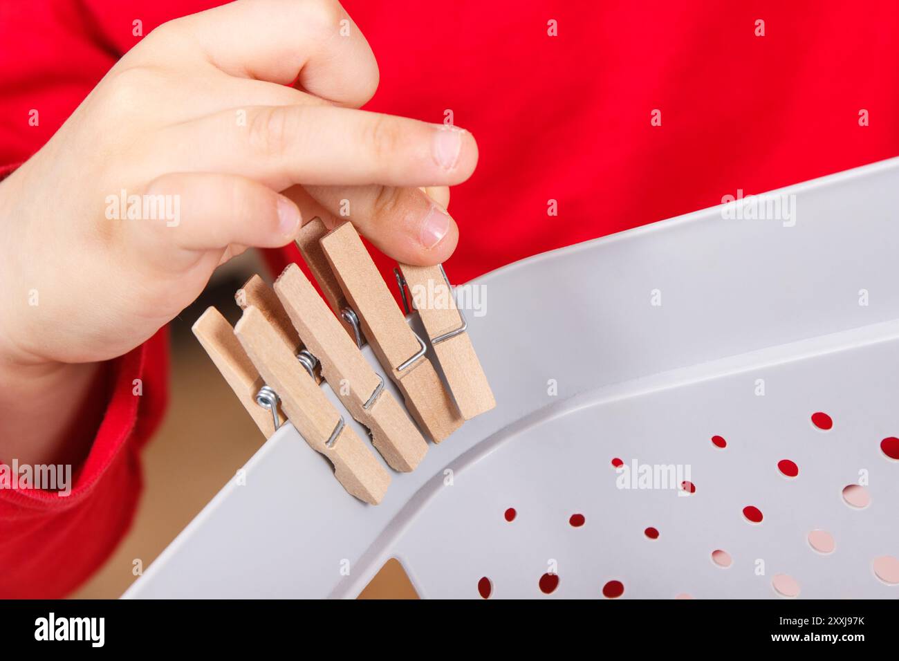 Preschooler playing with wooden clip. Development of kids motor skills ...