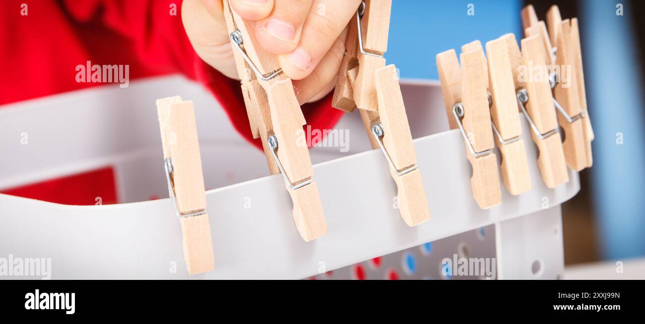 Preschooler playing with wooden clip. Development of kids motor skills ...