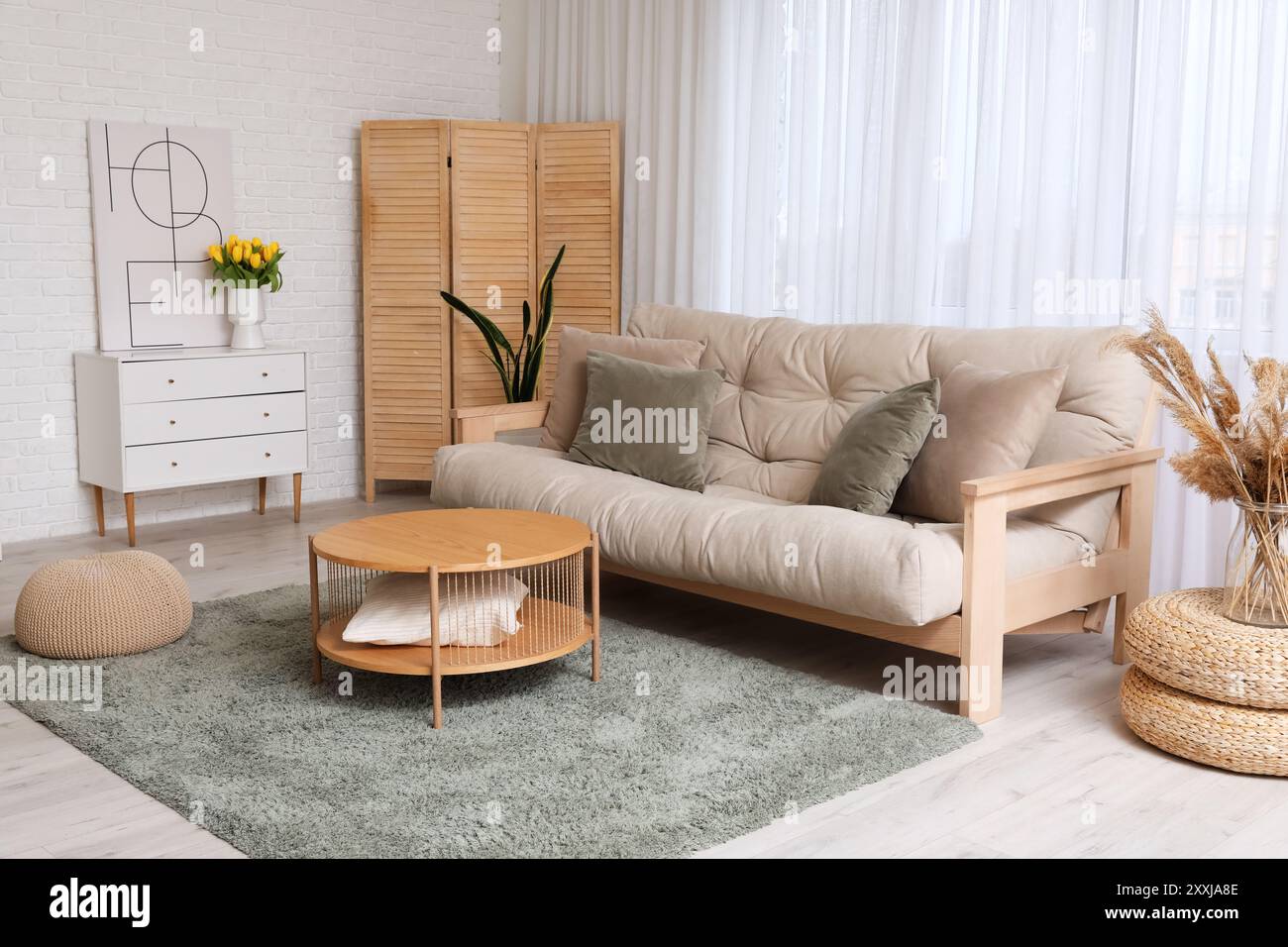 Wooden folding screen and table in interior of modern living room Stock ...