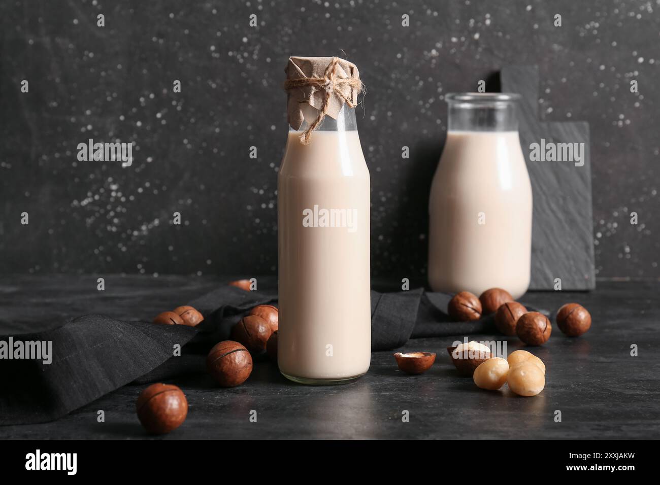 Bottles of fresh macadamia milk on black background Stock Photo - Alamy