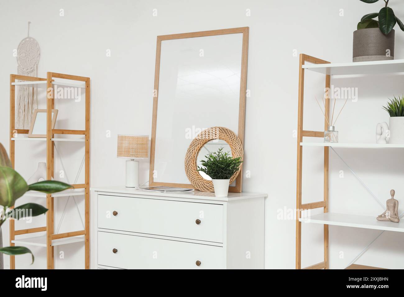 Interior of light living room with commode and shelf units Stock Photo ...