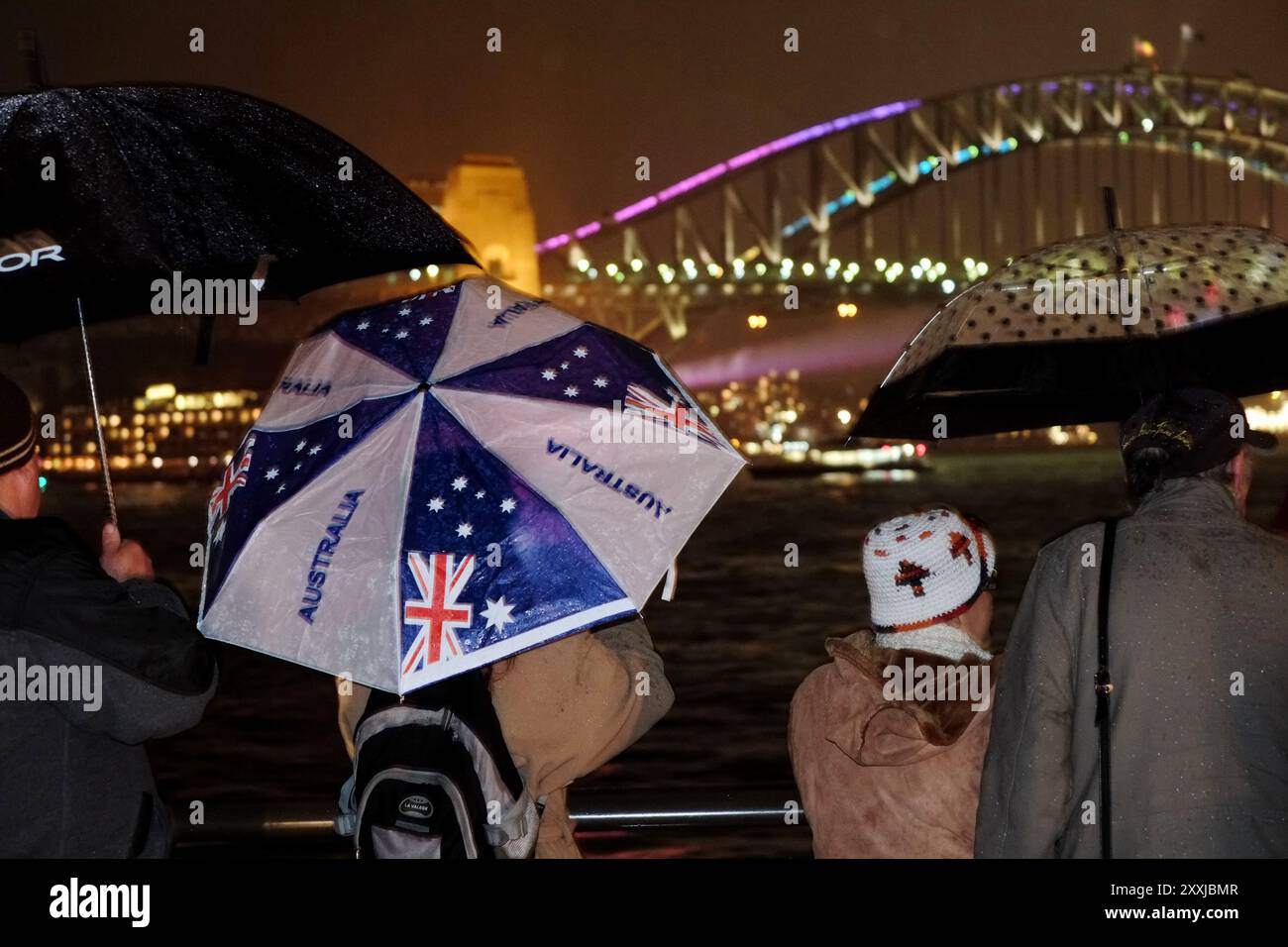 Australian Flag umbrella in the rain at night during the VIVID Sydney ...