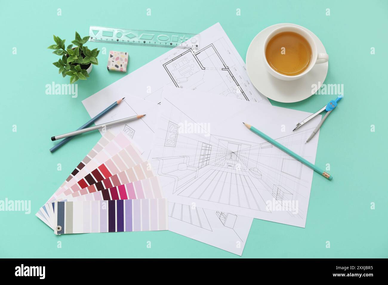 Architect's supplies with house plans, tea cup and paint color palettes ...