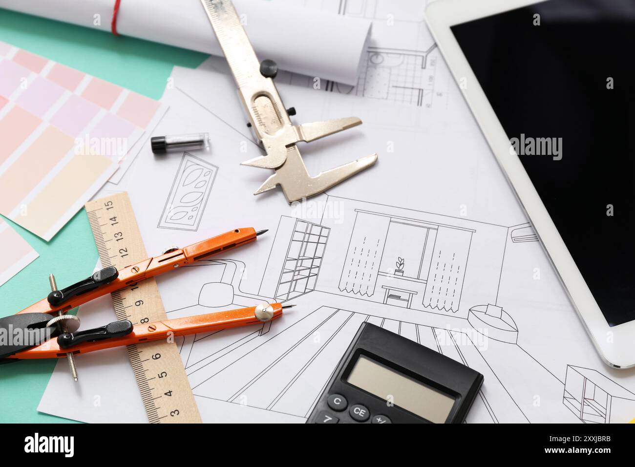 Architect's supplies with house plans and tablet computer on green ...