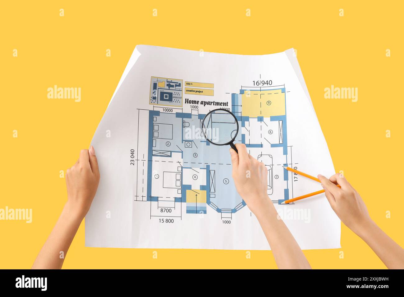 Architects with house plan and magnifier on yellow background Stock ...