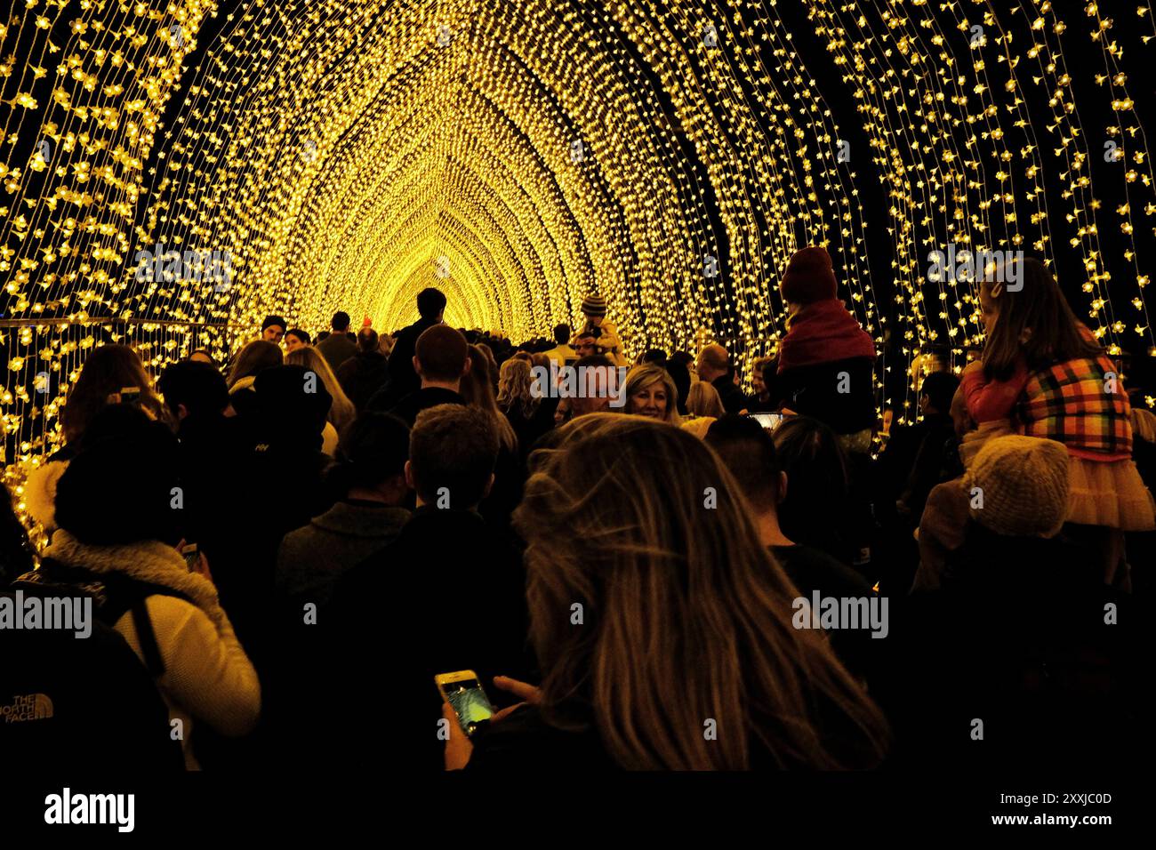 People inside the Cathedral Of Light, children raised on shoulders in a ...
