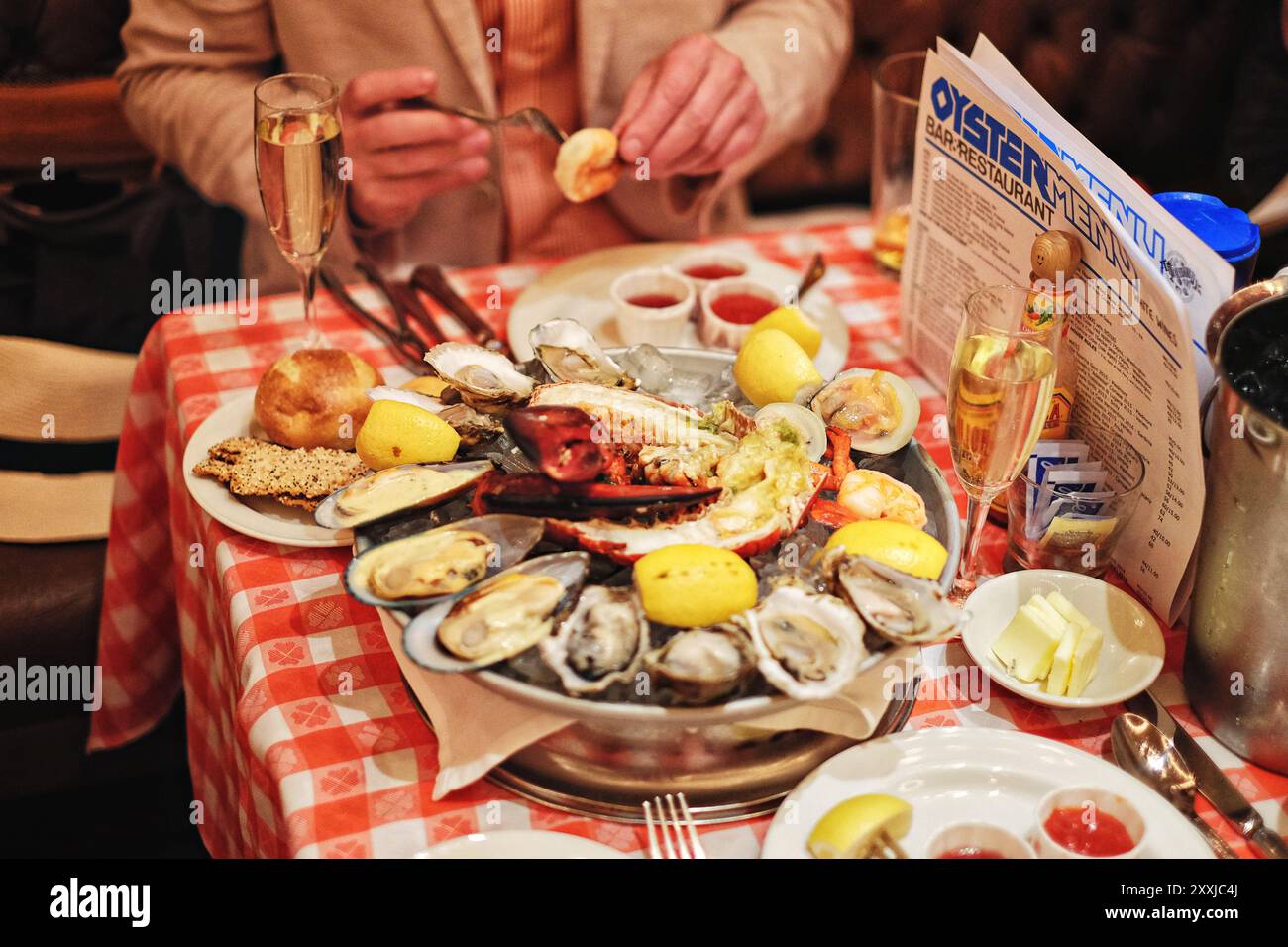 A man enjoying a shrimp from the Seafood Platter at Grand Central ...