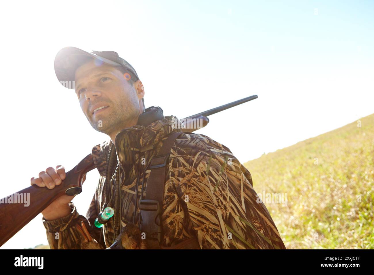 Man, hunter and rifle in outdoor for sport, activity and trophy as ...