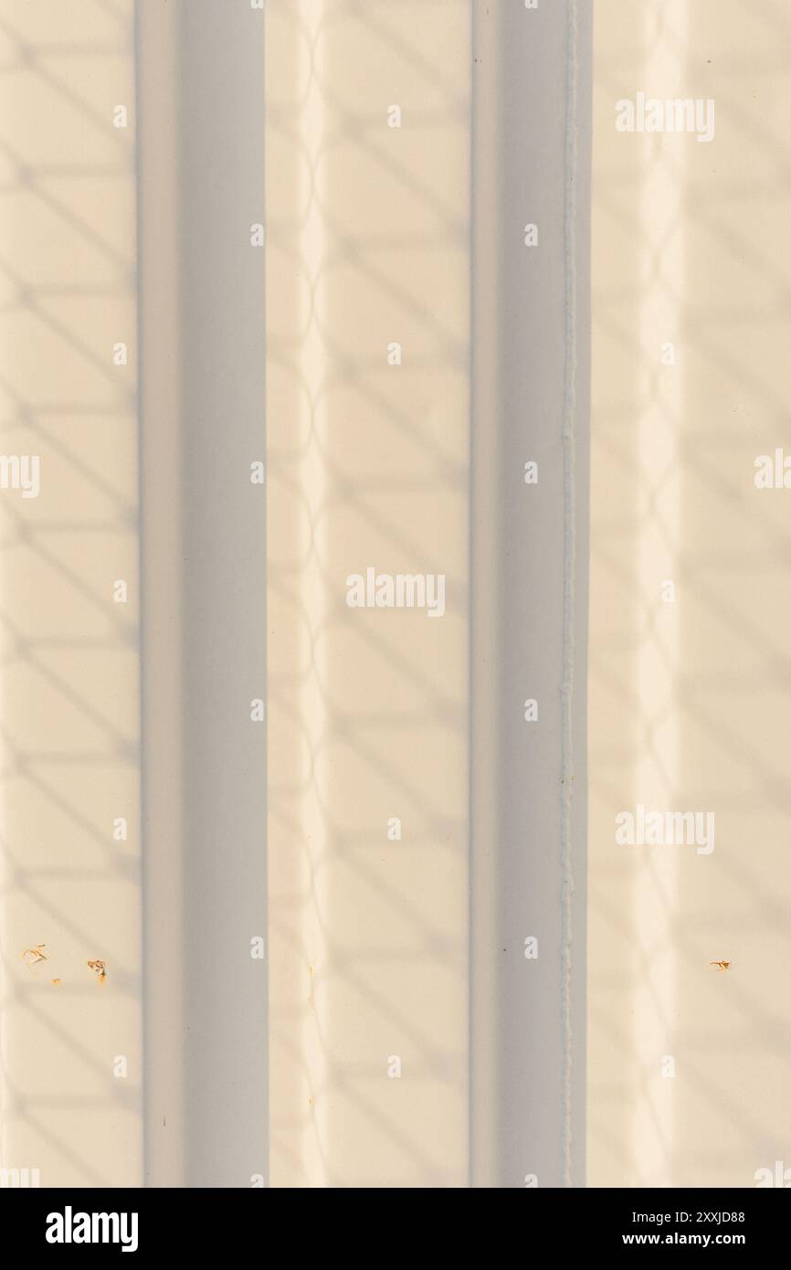 chainlink pattern shadow on white shipping container Stock Photo - Alamy