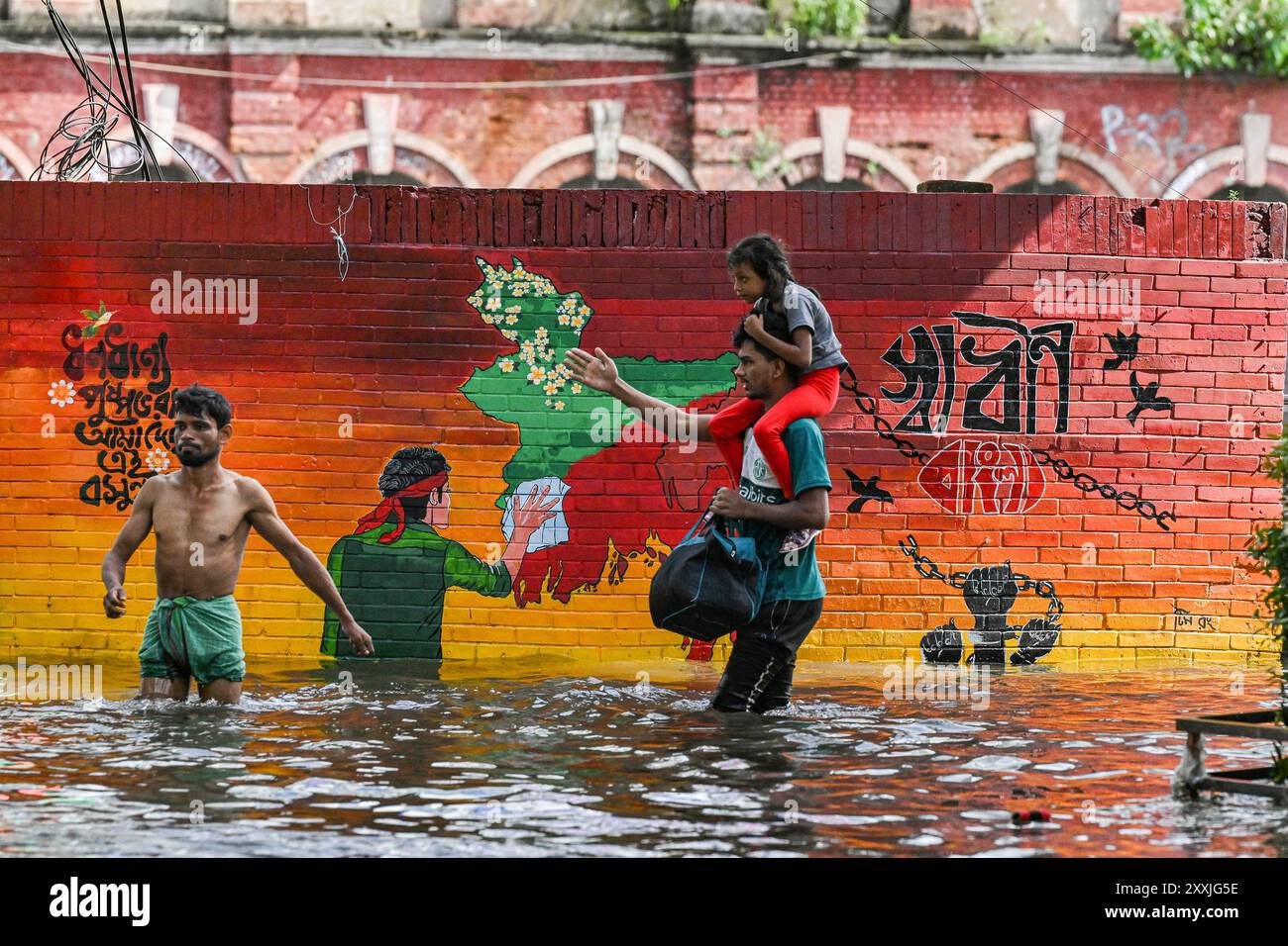 Dhaka, Bangladesh. 24th Aug, 2024. People wade through floodwater in ...