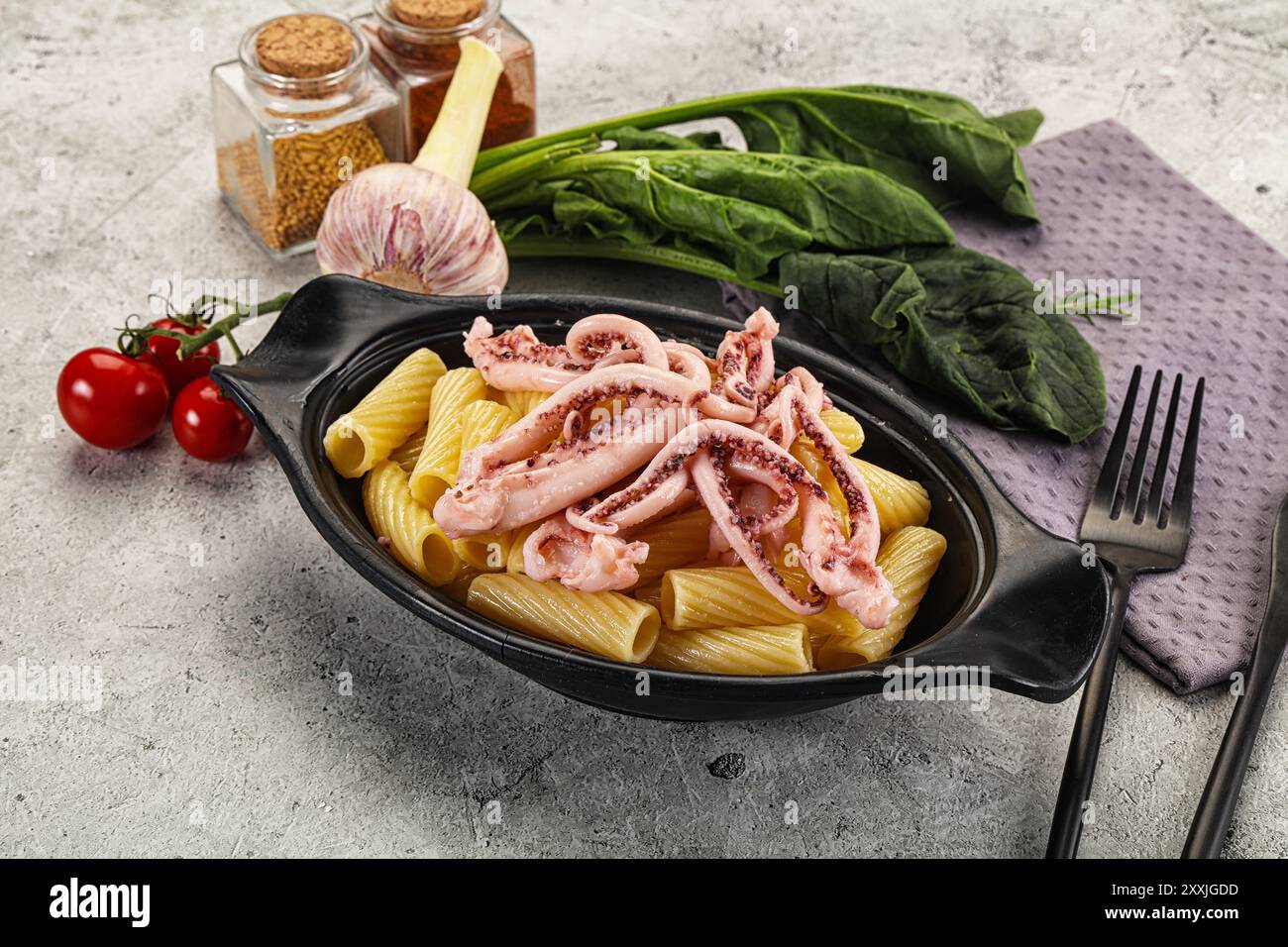 Italian cuisine - pasta tortiglioni with squid tentacles Stock Photo ...