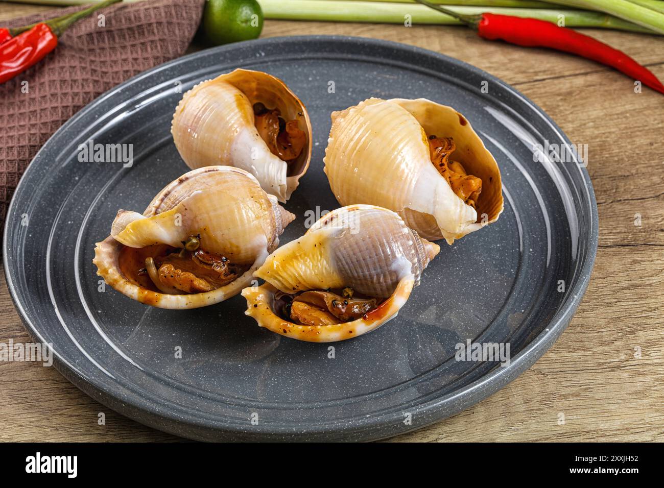 Delicous Snails baked with garlic and spices Stock Photo - Alamy