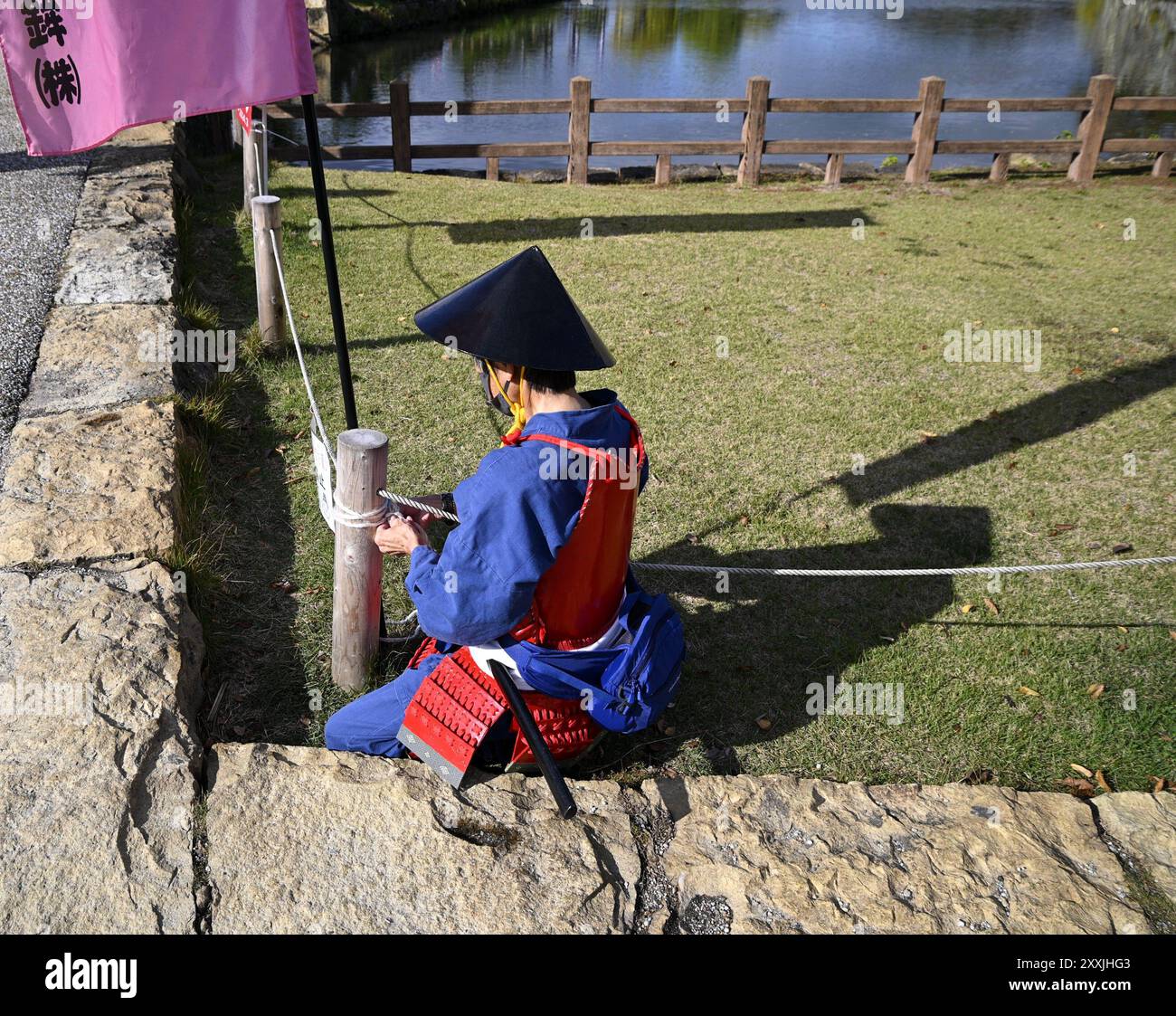 Japanese man on a traditional costume tying a Japanese Otoko Musubi ...