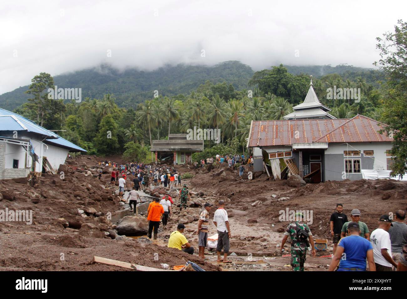 Rescuers and villagers search for missing people, following a flash ...